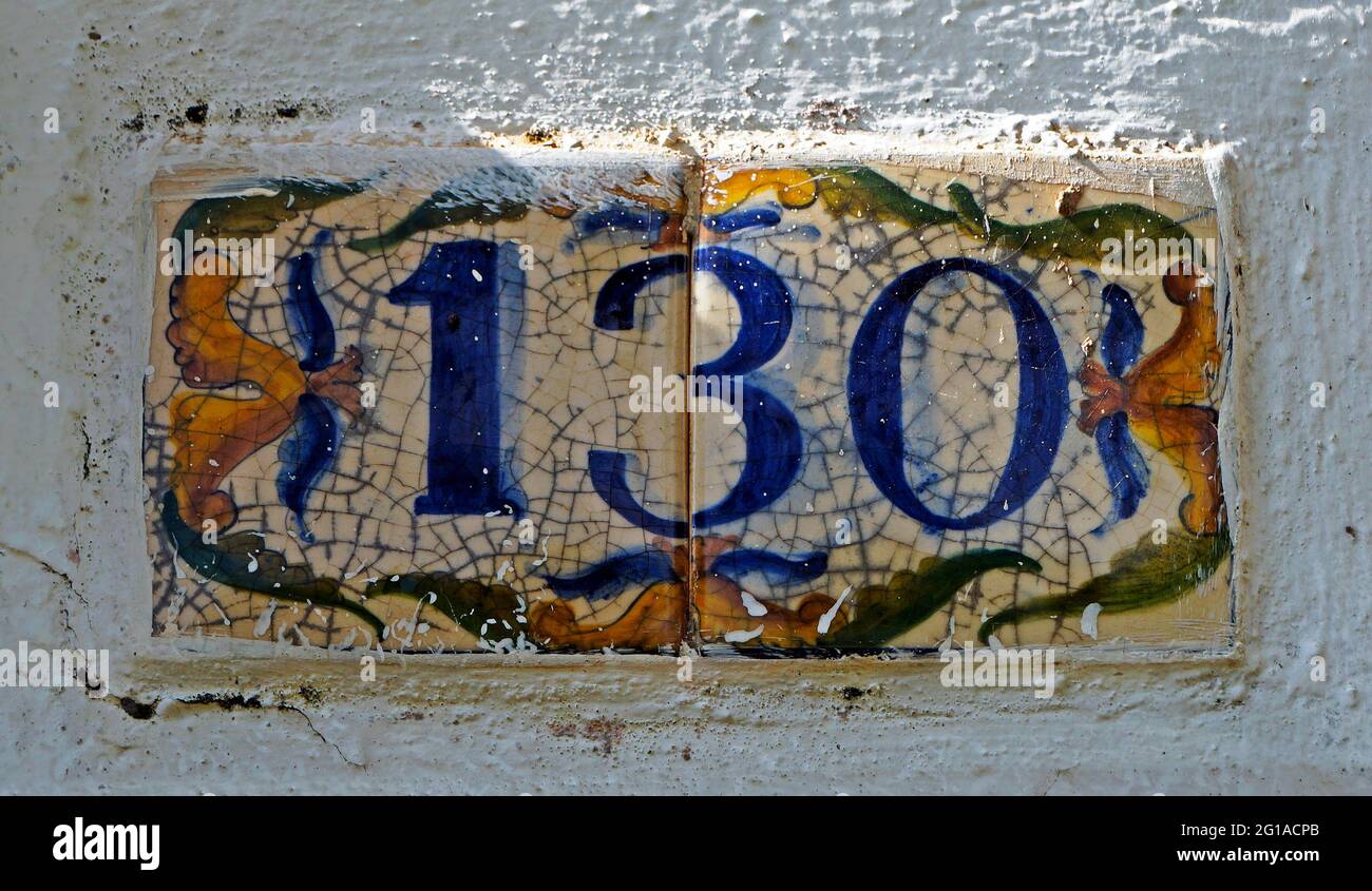 Street sign number 130 on a white wall Stock Photo - Alamy