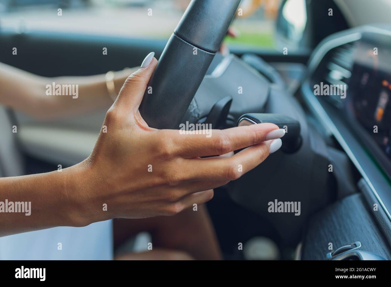 Woman's hand switches the lobes of the gear selector on the steering ...