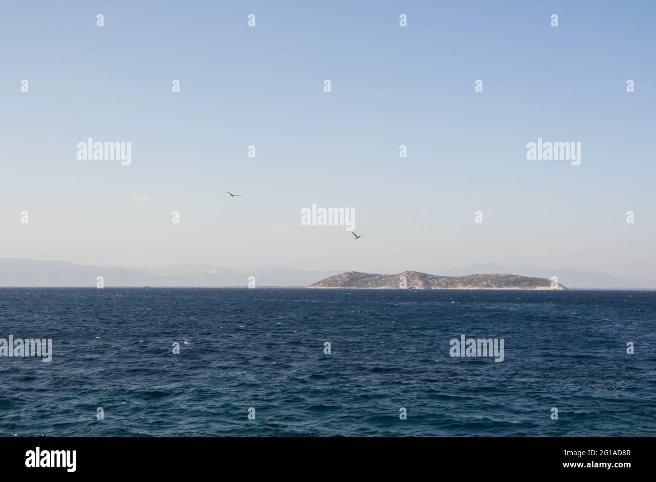 Small distant land in the ocean, beautiful blue ocean and blue sky ...
