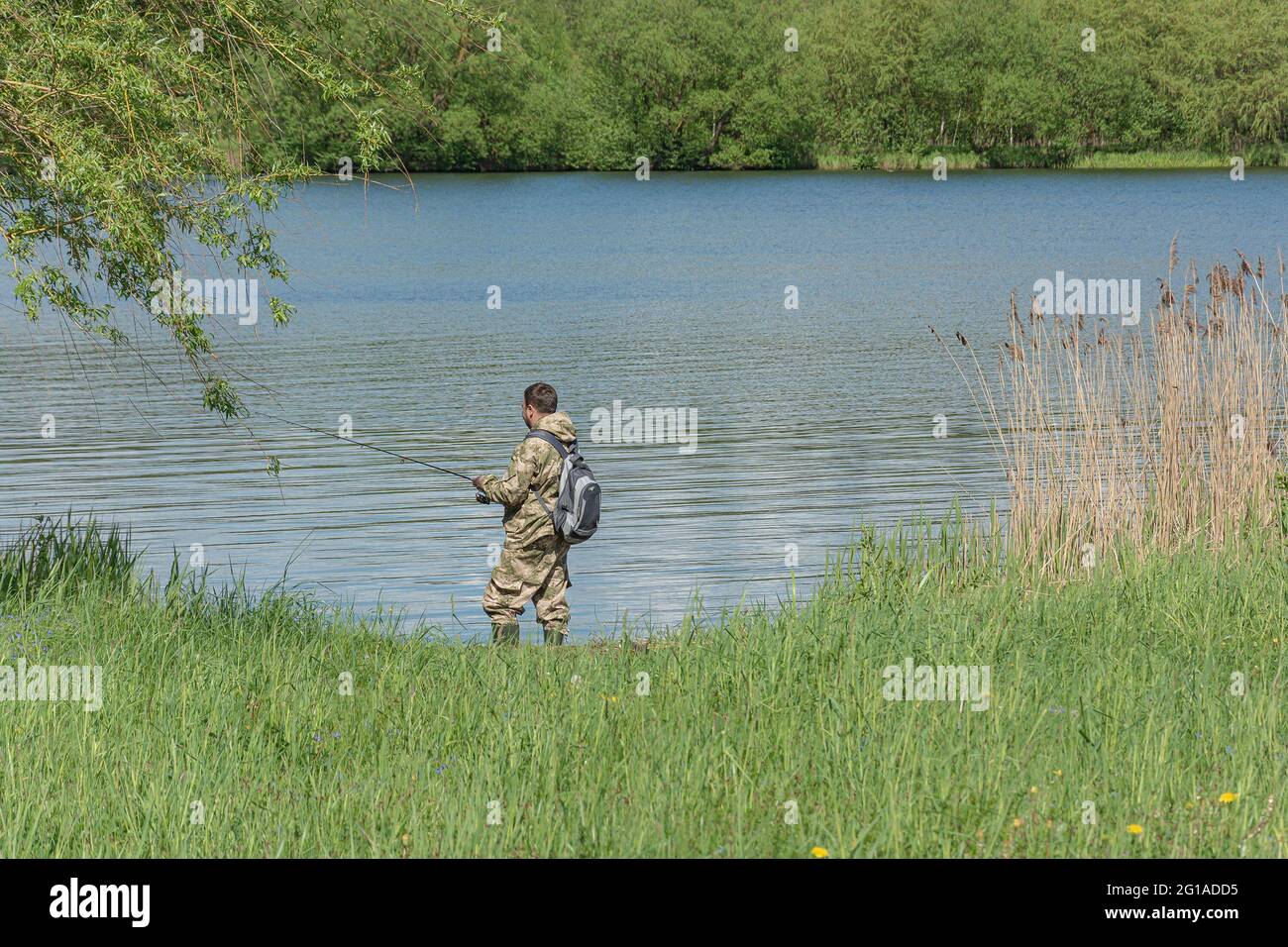 A fisherman catches fish on the river bank. Stock photo Stock Photo - Alamy