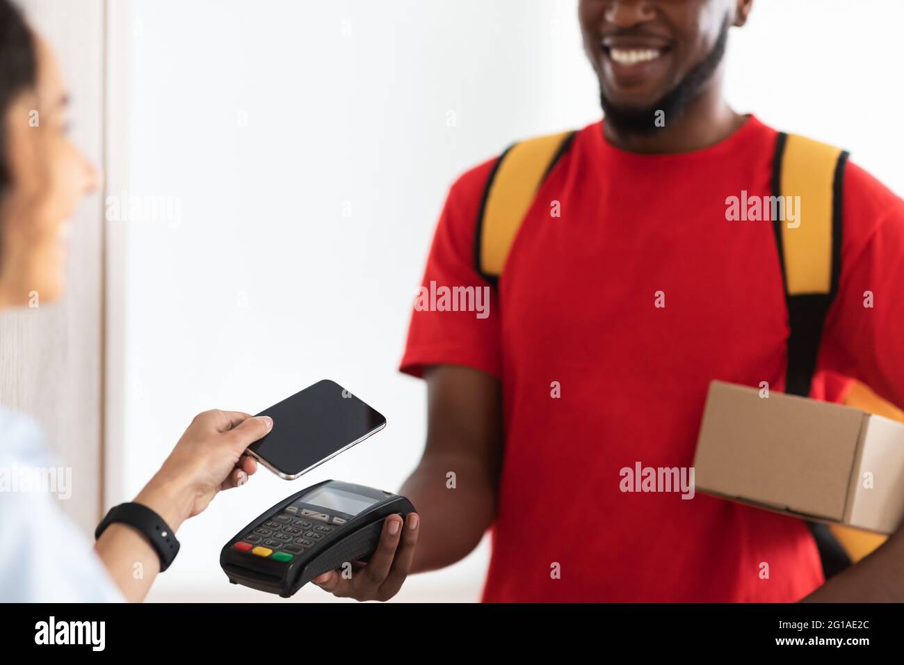 Delivery man giving payment terminal hi-res stock photography and ...