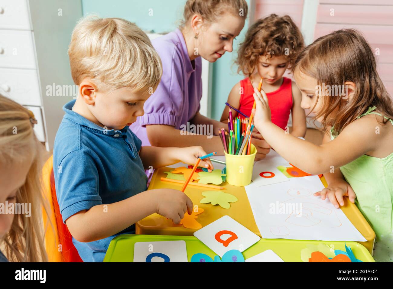 Preschool children learn english alphabet using cards Stock Photo - Alamy