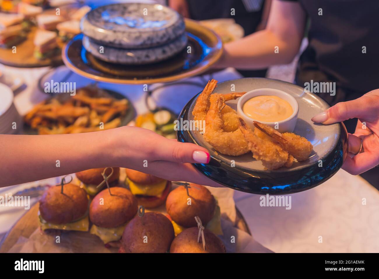 Small burgers served on one plate as appetizers Stock Photo - Alamy