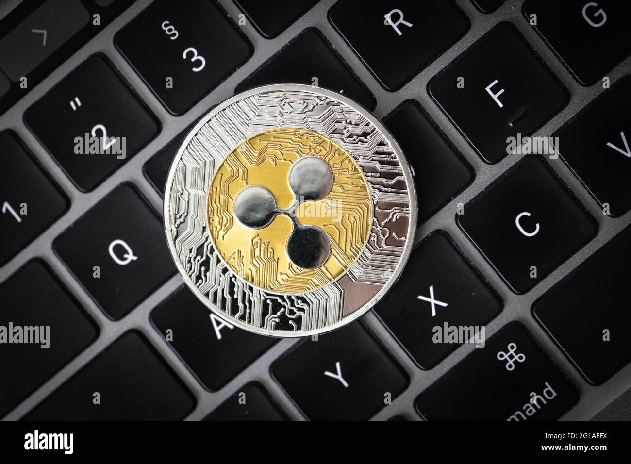 Ripple cryptocurrency physical coin laying on a laptop keyboard Stock ...