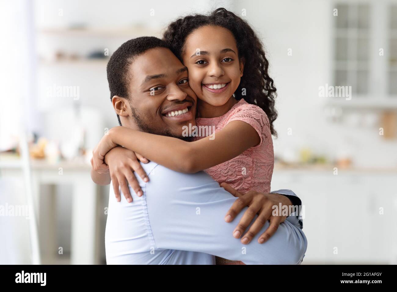 Adorable black family father and daughter hugging, copy space Stock Photo - Alamy