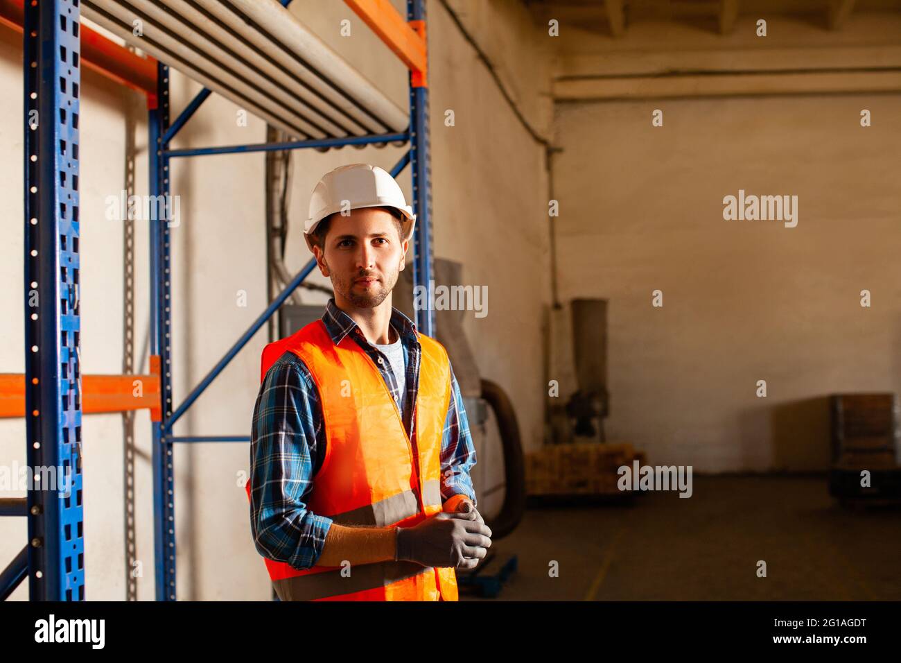 Portrait of young man member of factory staff Stock Photo - Alamy