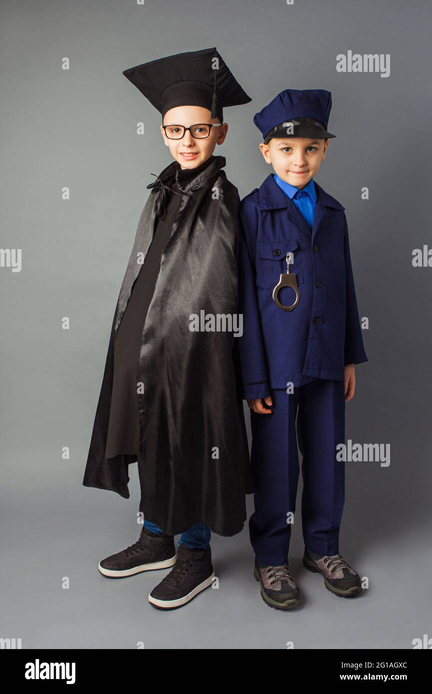 The little boys dressed in a costumes of officer and judge Stock Photo ...