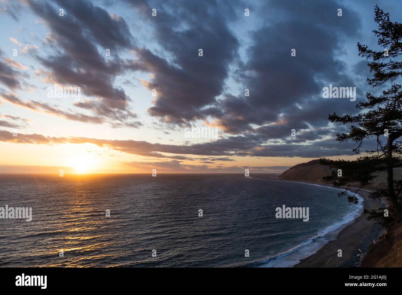 A dramatic sunset over the ocean with colorful skies and color being ...