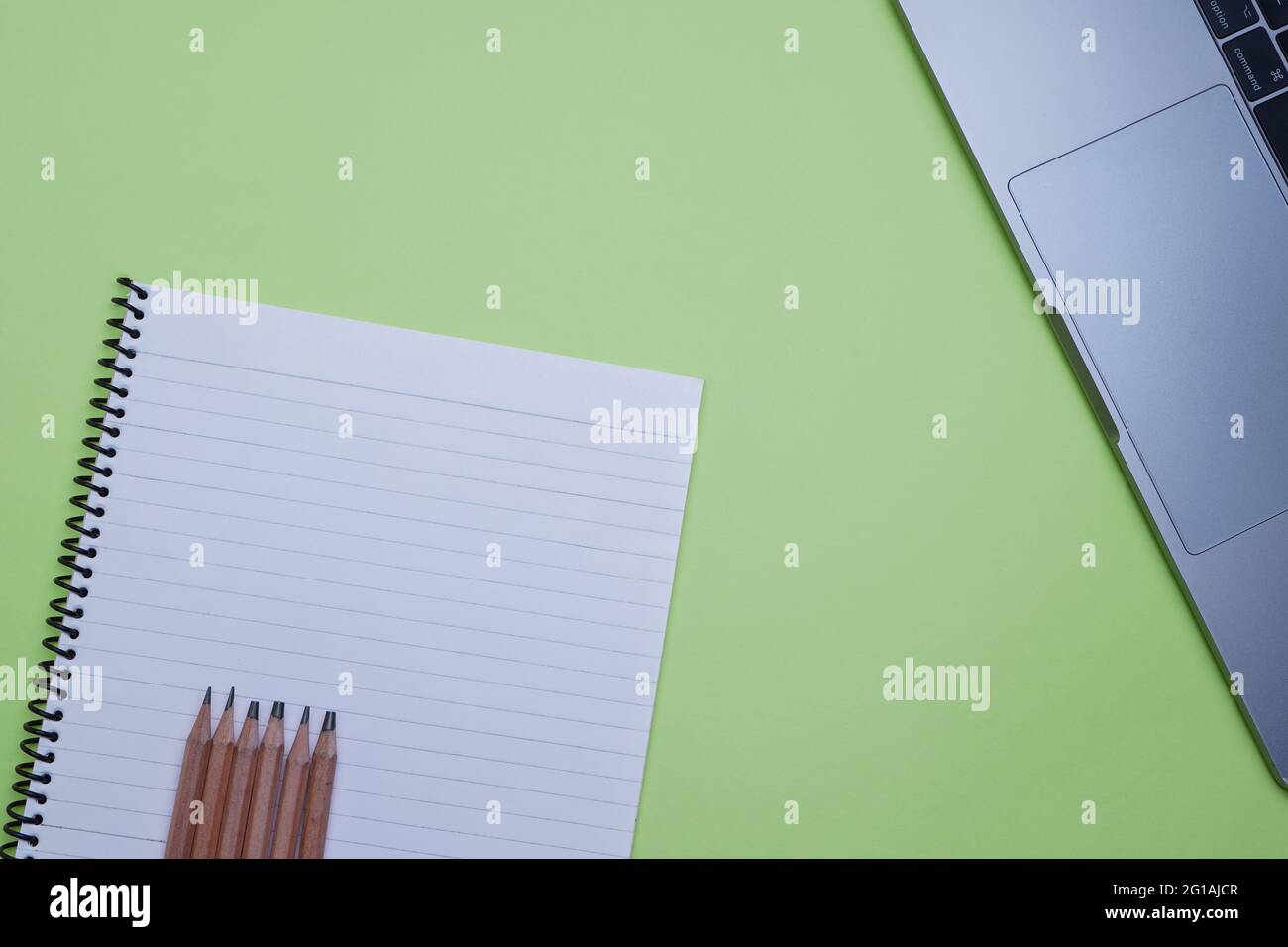 Office top view for corporate use. Laptop, pencils and a notebook on a ...