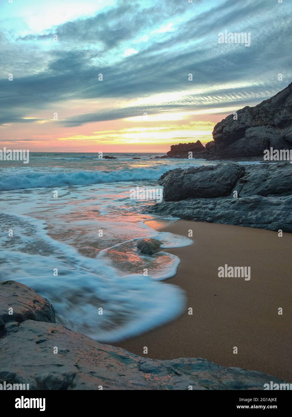 A vertical shot of a scenic sunset at the beach Stock Photo - Alamy