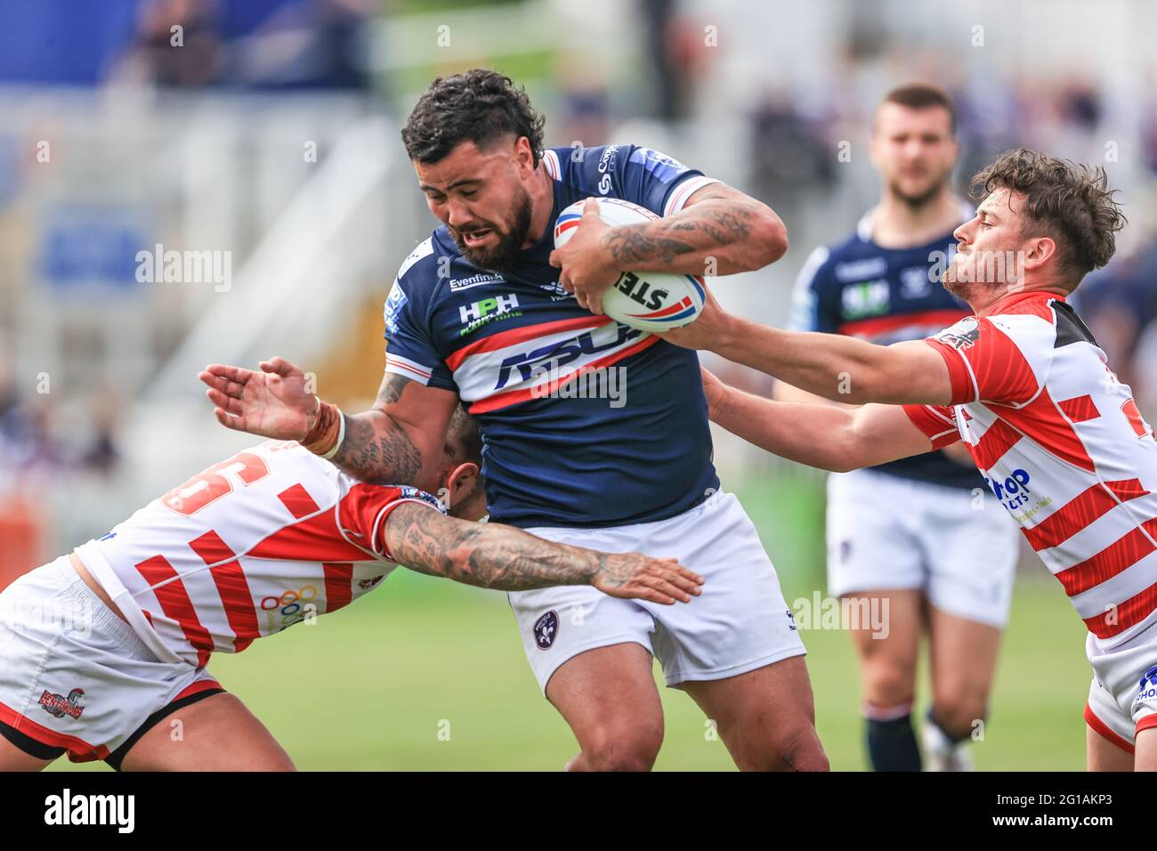 David Fifita (8) of Wakefield Trinity is tackled by Craig Mullen (22 ...