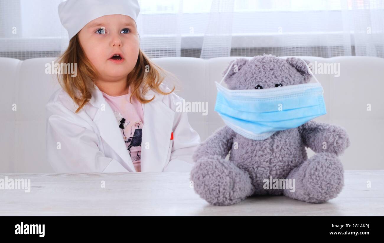 little girl plays a doctor, makes an injection. Happy child little ...