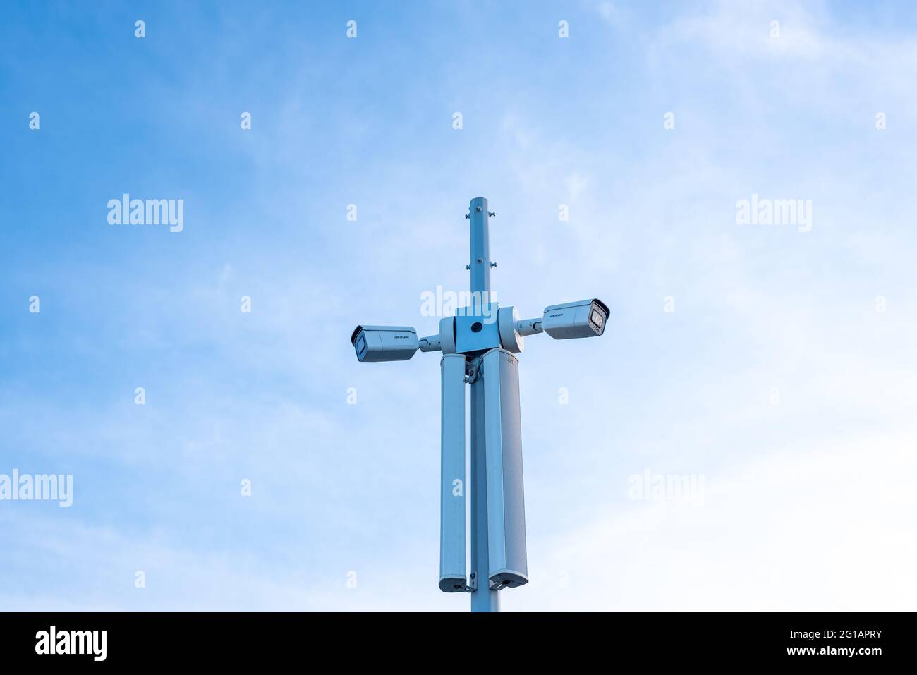 Surveillance cameras to control protected area on high pole Stock Photo ...