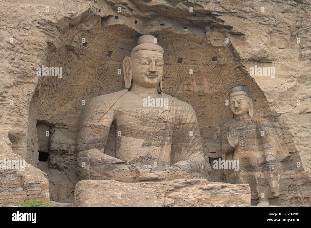 A massive carved image of Buddha in the cliff face at the Yungang ...