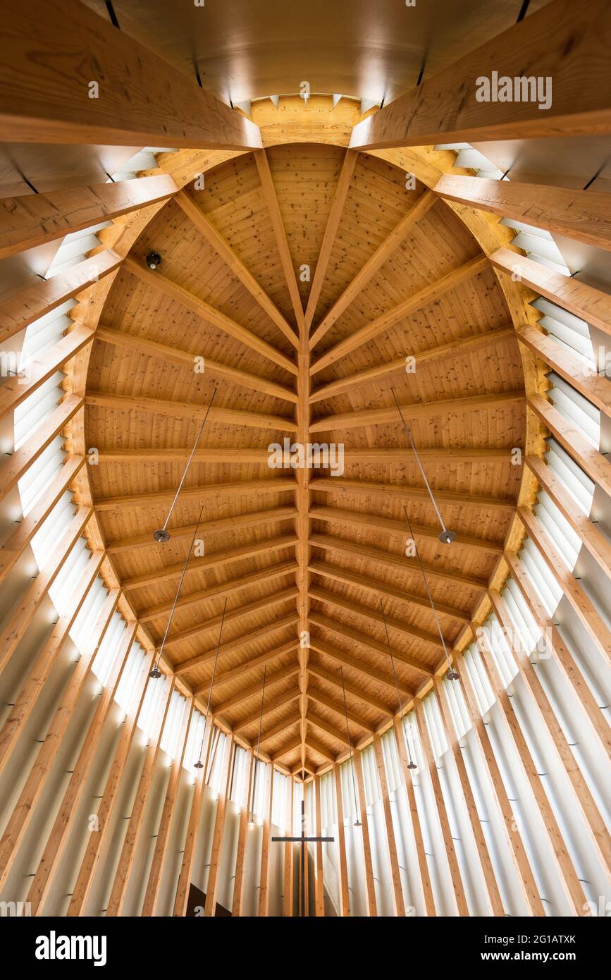 A low angle shot of a church auditorium with a wooden design of walls ...