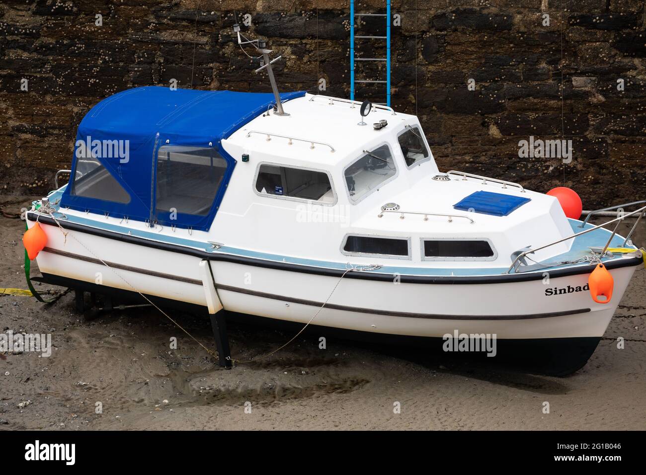 Sinbad, a small boat sitting on the harbour floor at low tide in ...