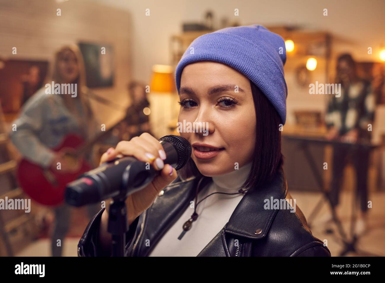 Standing singing performance holding microphone hi-res stock ...