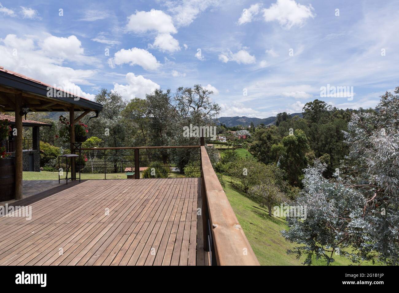 Large wood deck near house with spring landscape Stock Photo - Alamy