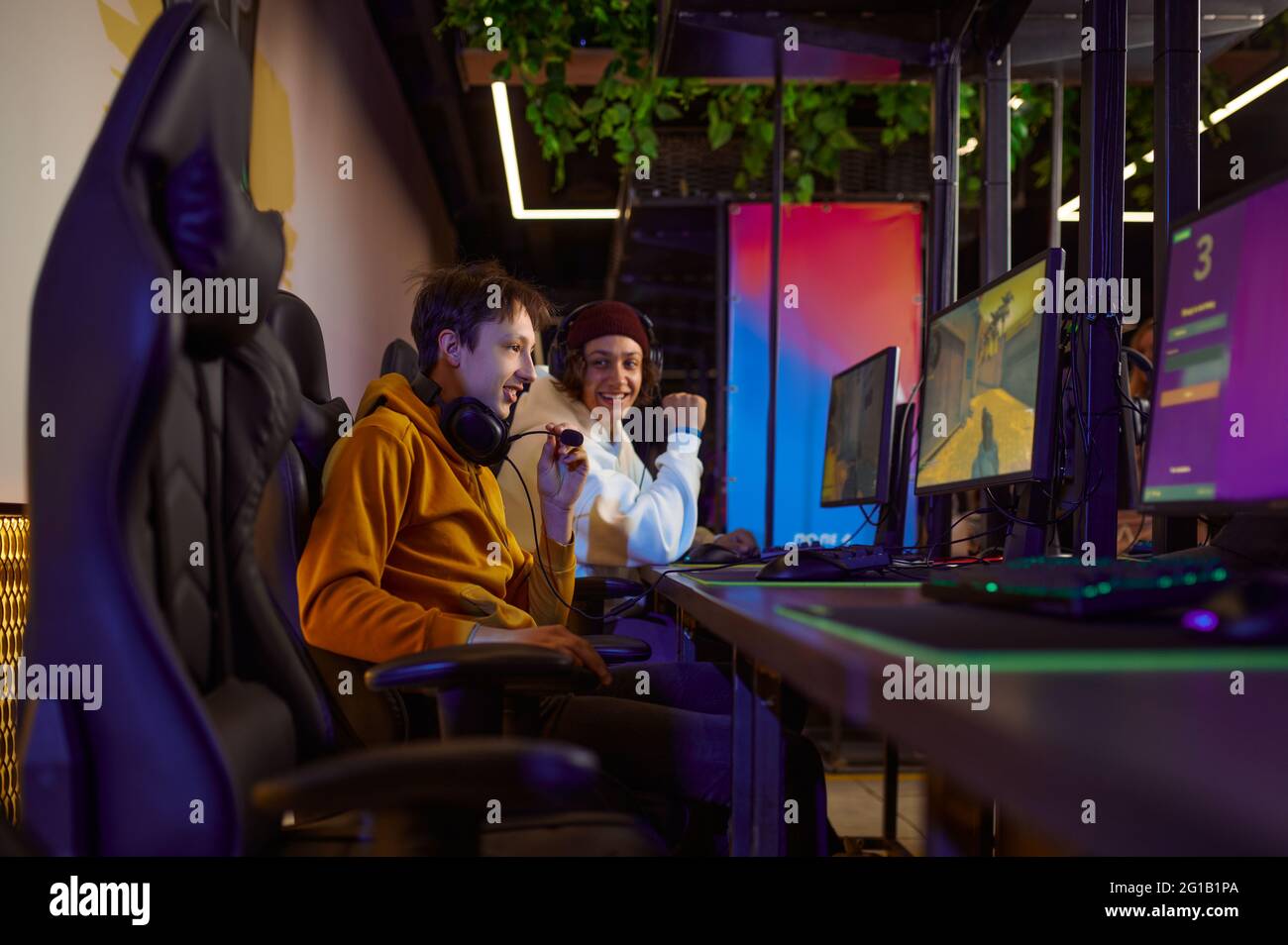 Two young gamers play in game club Stock Photo - Alamy