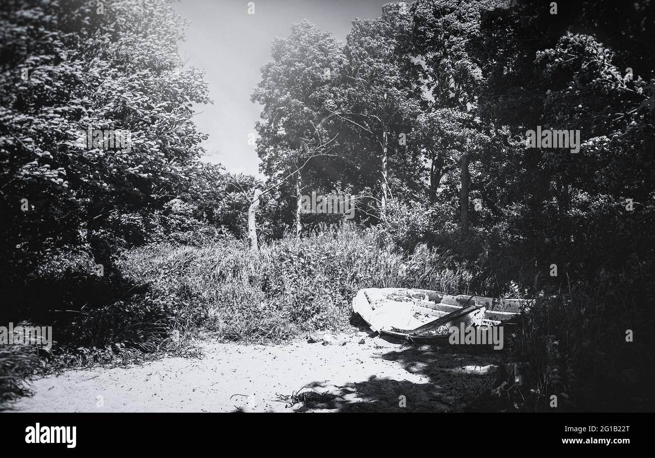A lonely, wrecked, rotten fishing boat lies stranded in the middle of ...