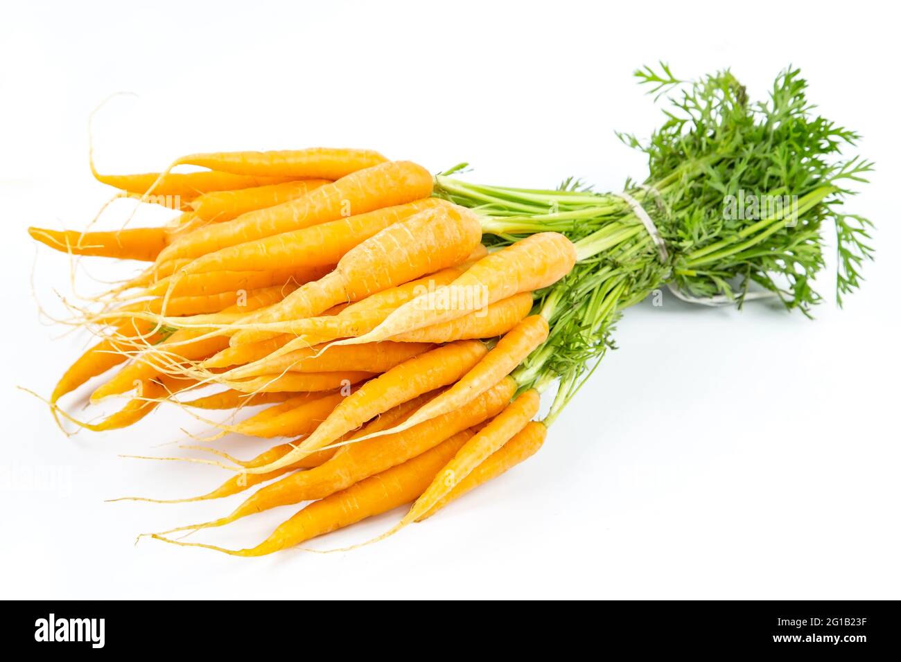 Fresh spring carrots isolated on white background Stock Photo - Alamy