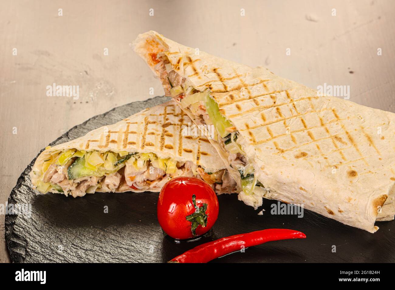 Tasty shawarma with meat, sauce and vegetables Stock Photo - Alamy