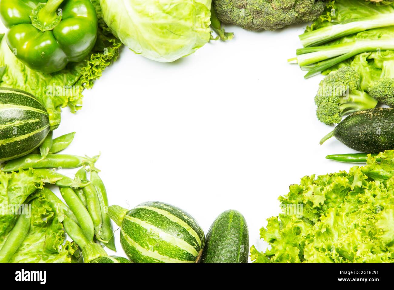 Green vegetables on white background Stock Photo - Alamy