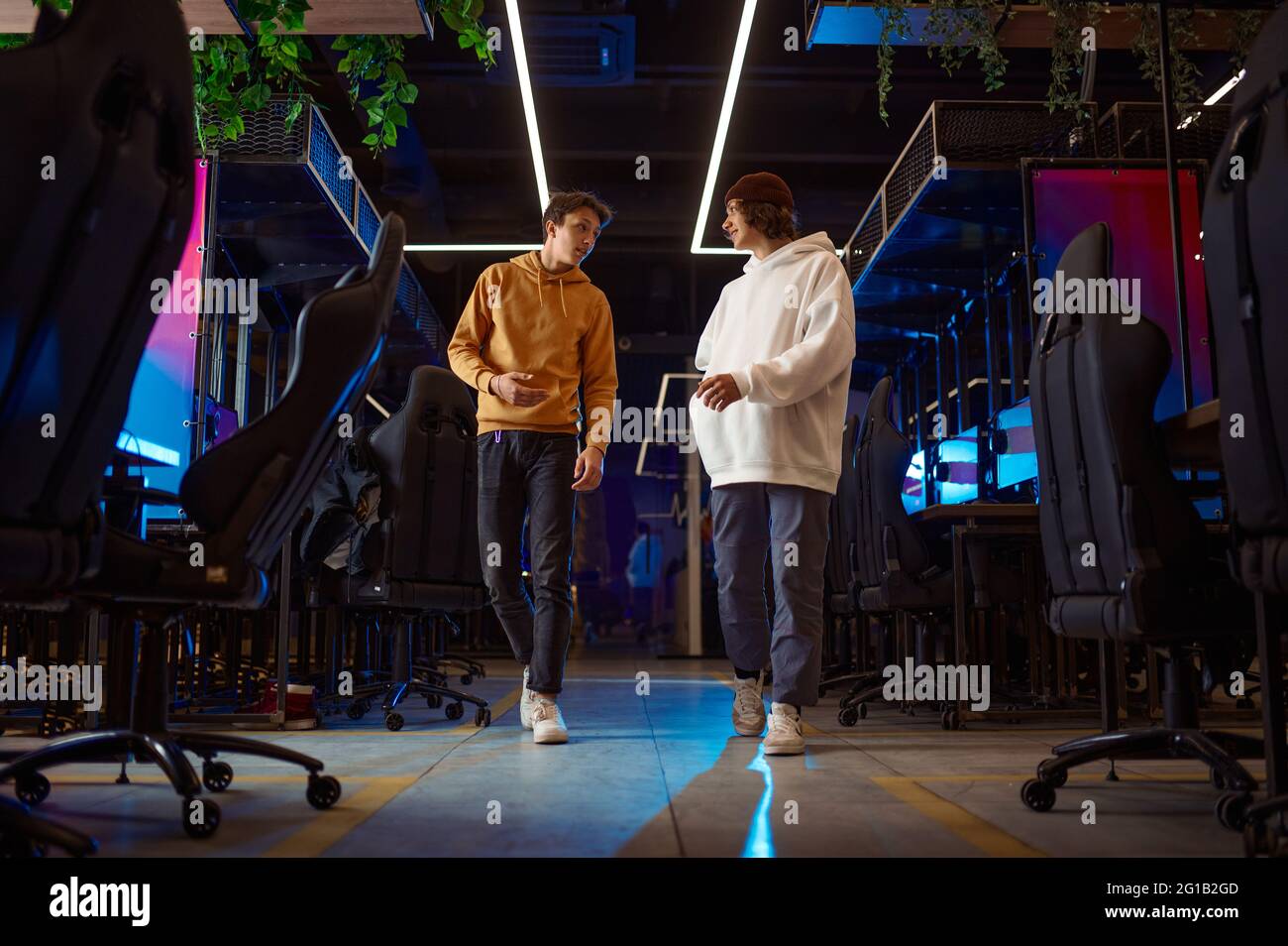 Two young gamers talking in game club Stock Photo - Alamy