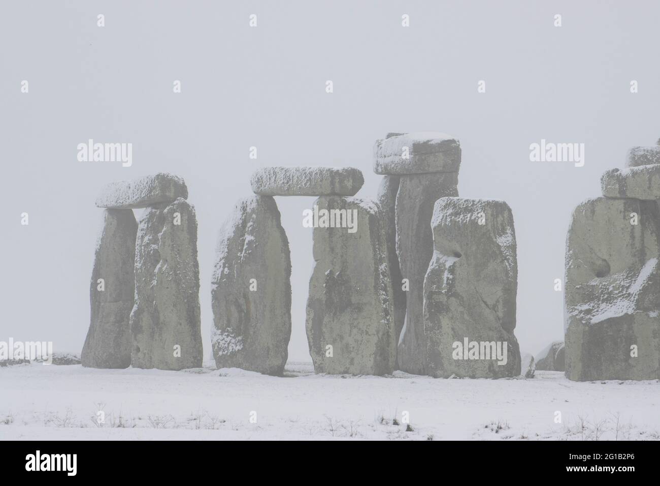 A snowy blizzard encircling the ancient isolated rocks of Stonehenge in ...