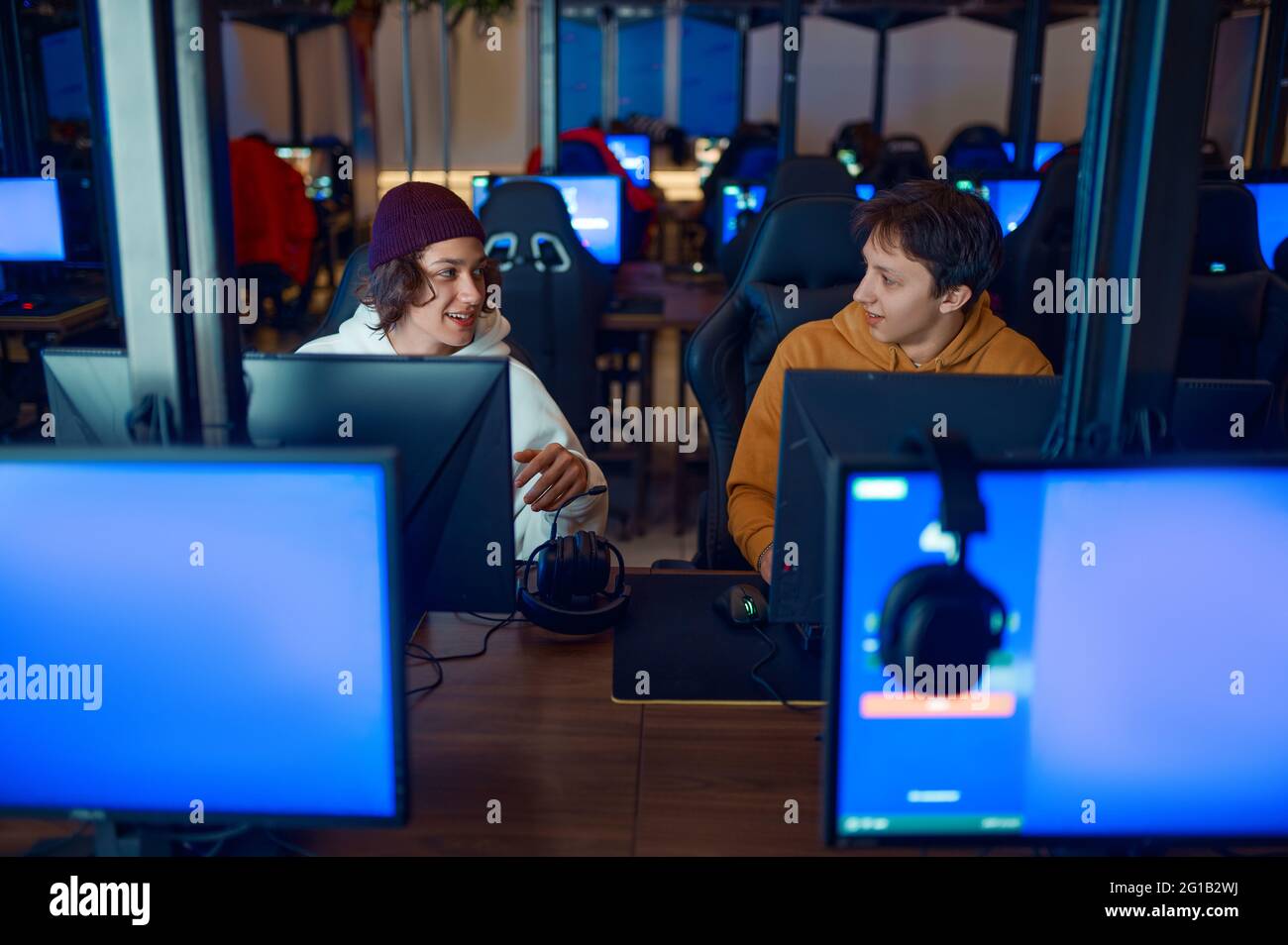 Two gamers play on computers in gaming club Stock Photo - Alamy