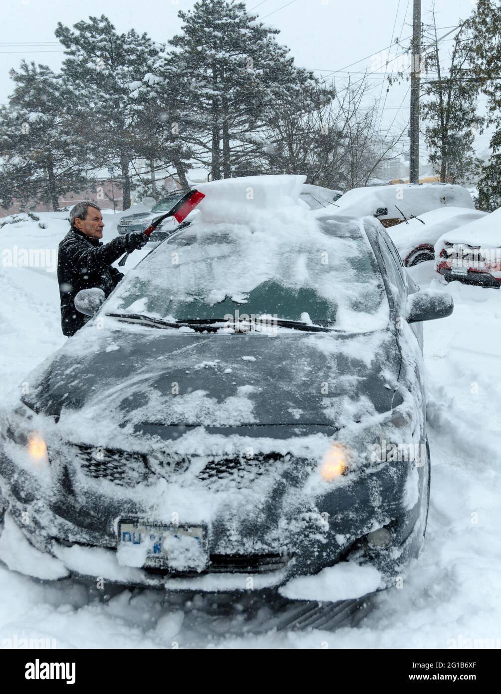Workers who finished their shift in a factory clean their cars of the ...