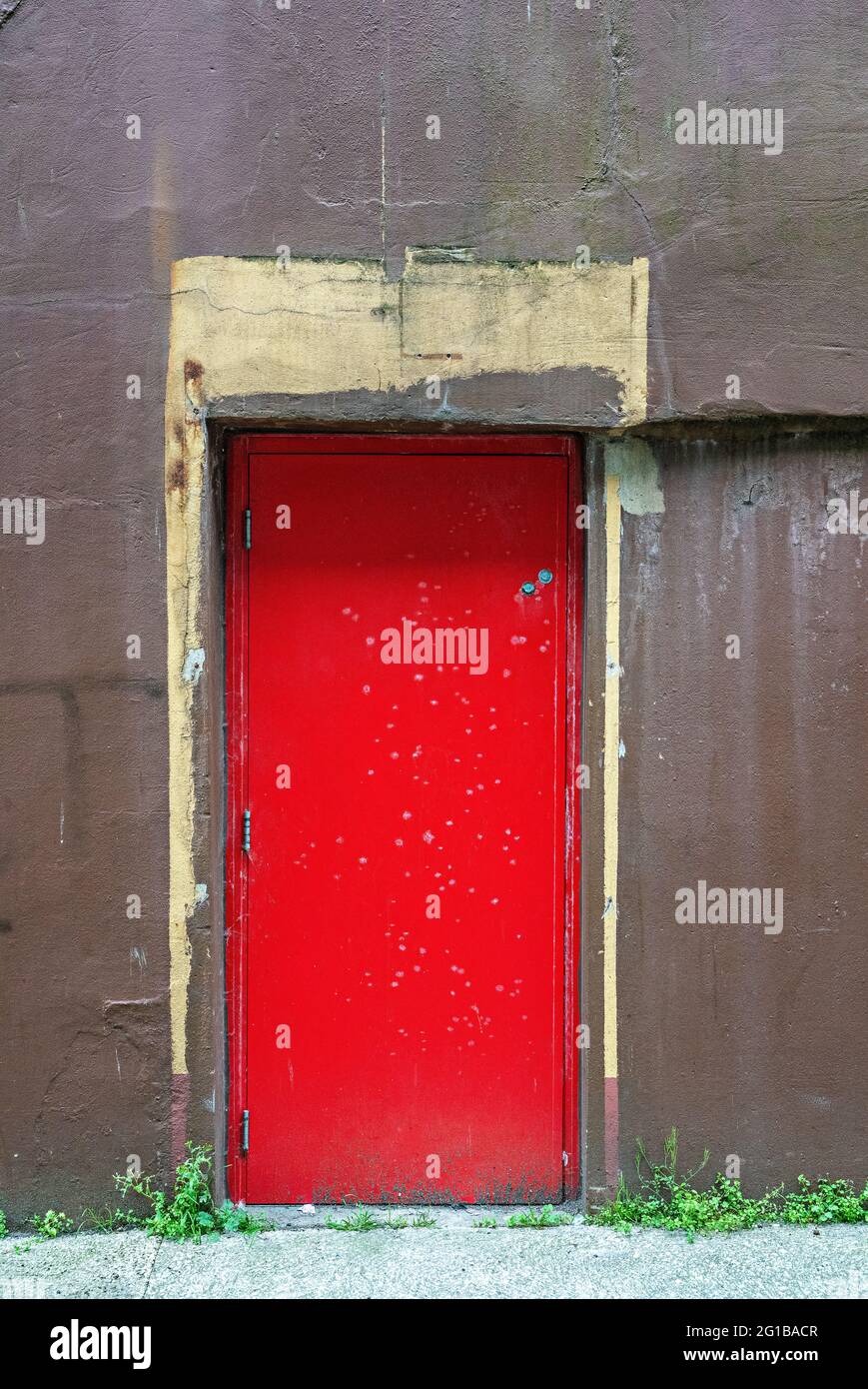 Red-painted street door set in brown-painted wall Stock Photo - Alamy