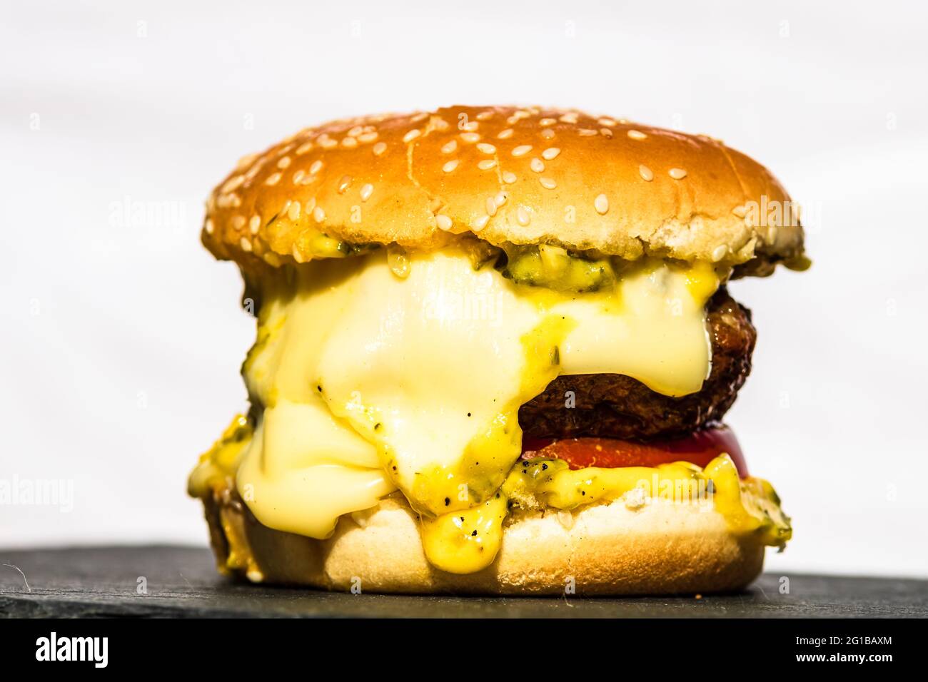 A fresh tasty beef burger with melted cheese isolated on a white ...