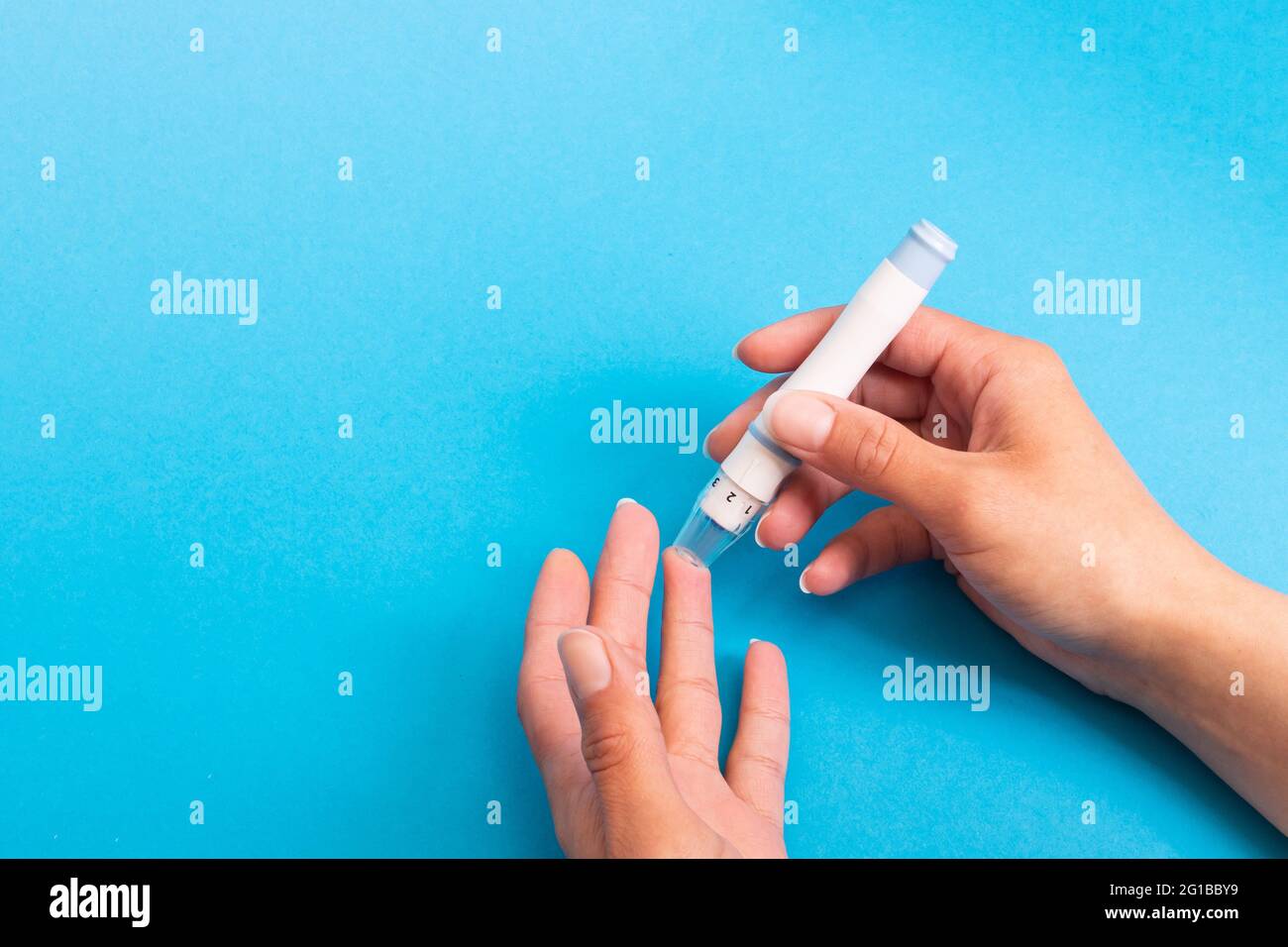 The lancet device pierces the finger close up Stock Photo - Alamy
