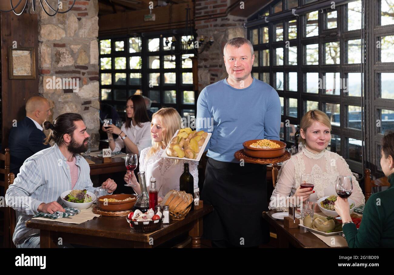 Country restaurant owner with traditional meals Stock Photo - Alamy