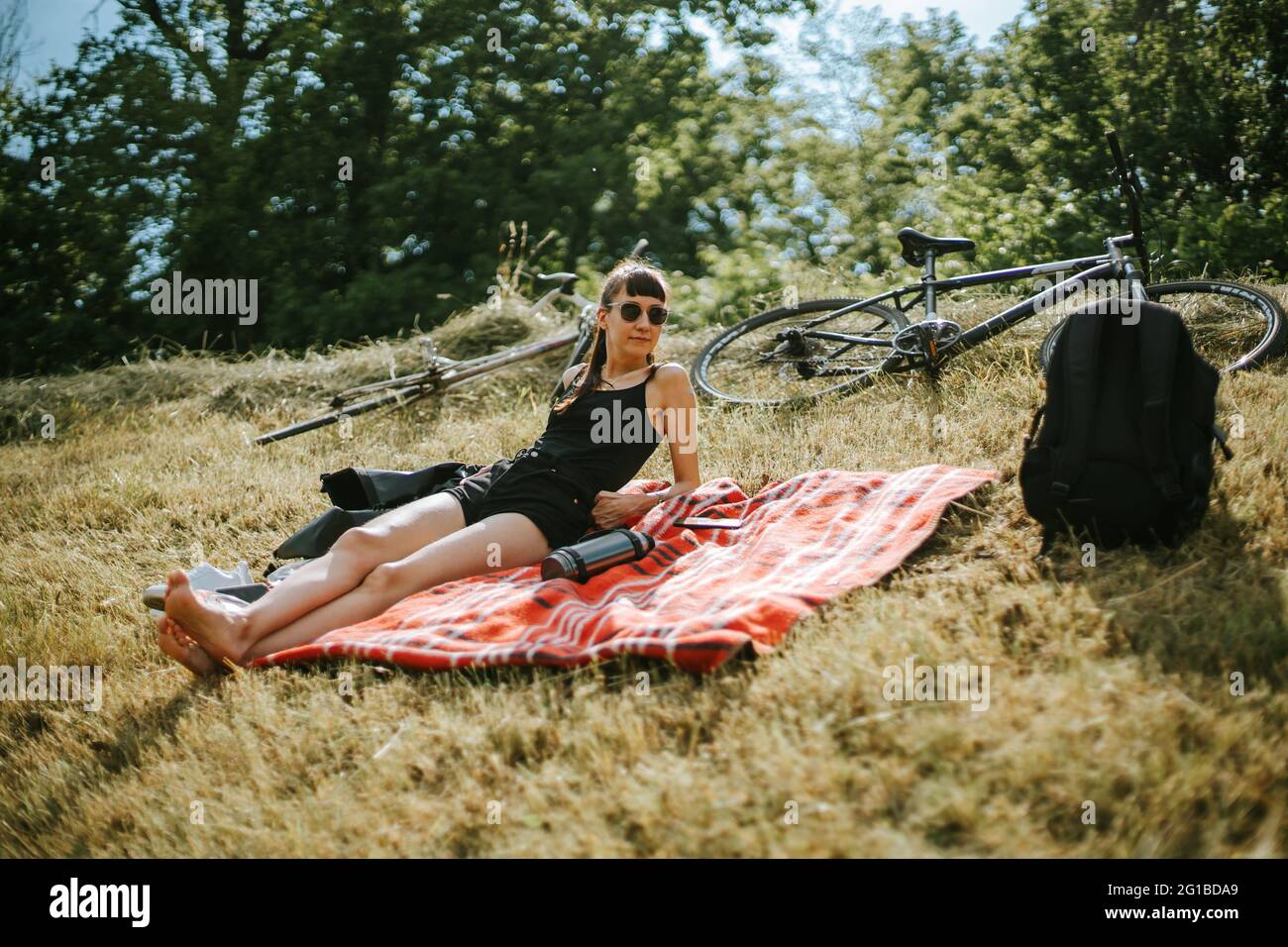 young woman relaxing on field Stock Photo - Alamy