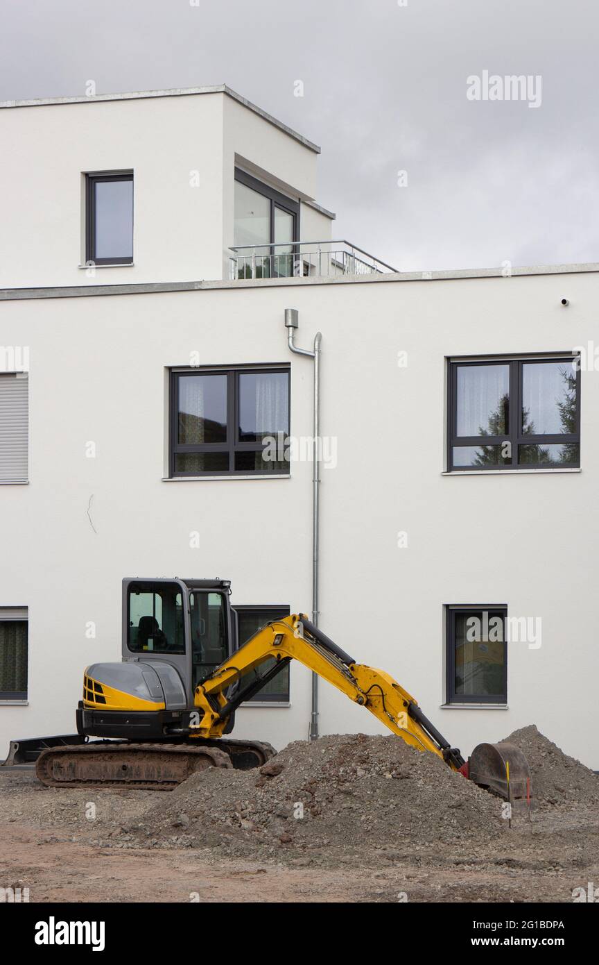 Building site of a new modern house with excavator Stock Photo - Alamy