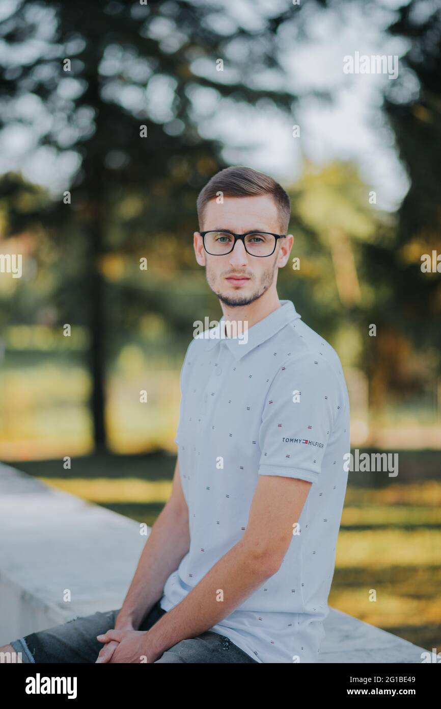 A portrait of a handsome guy in glasses outdoor Stock Photo - Alamy