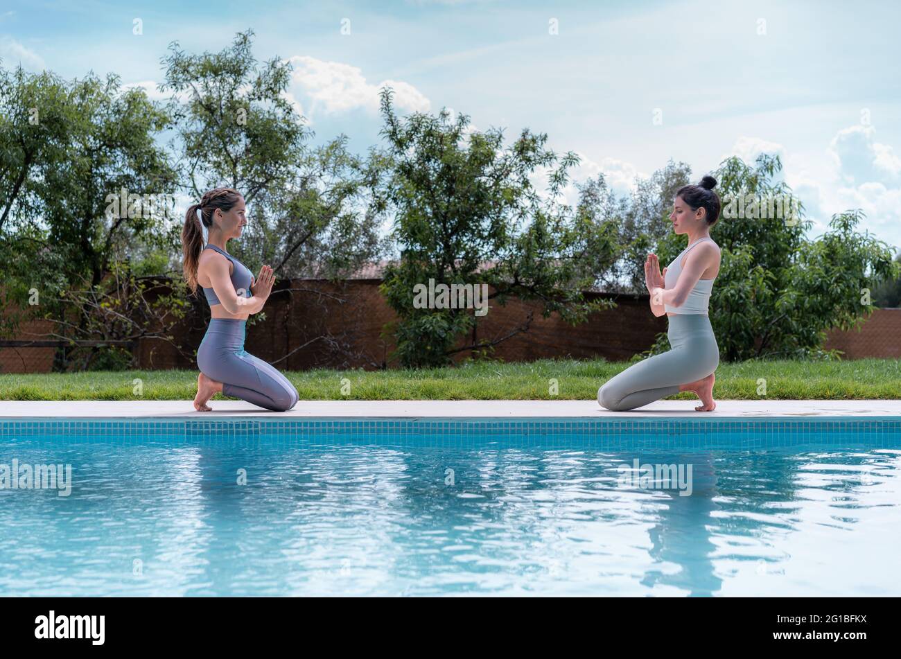 Side view of women in sportswear performing Toe Squat pose while ...