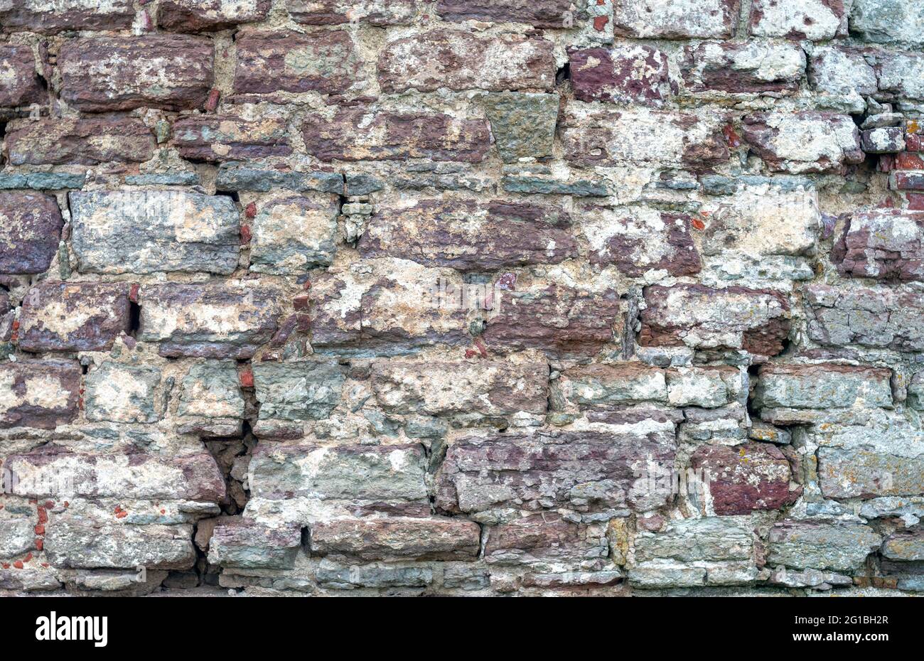 Texture of an old destroyed stone wall from the 17th century. Abstract ...