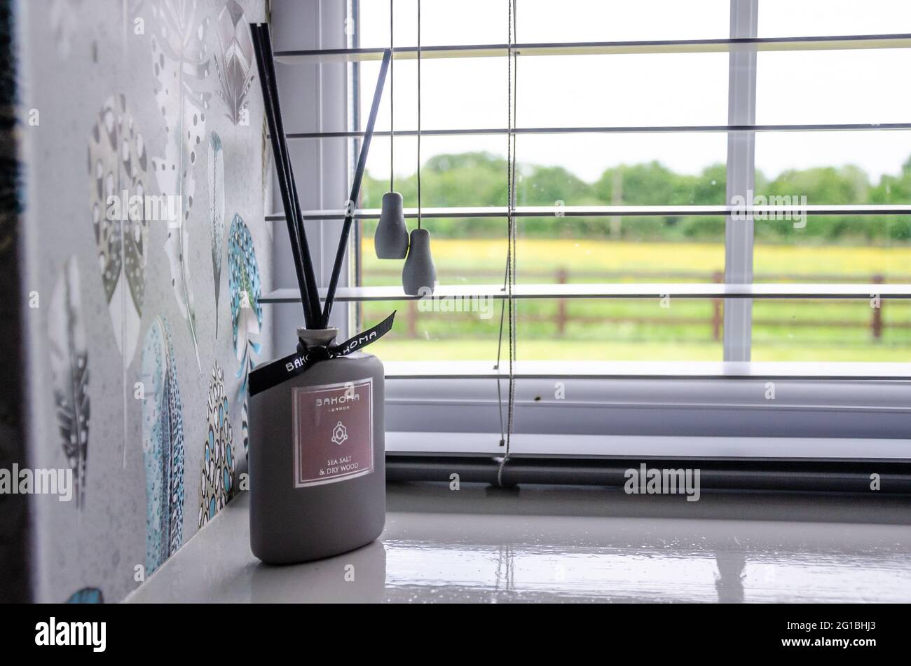 A diffuser style air freshener sits on a window sill Stock Photo - Alamy
