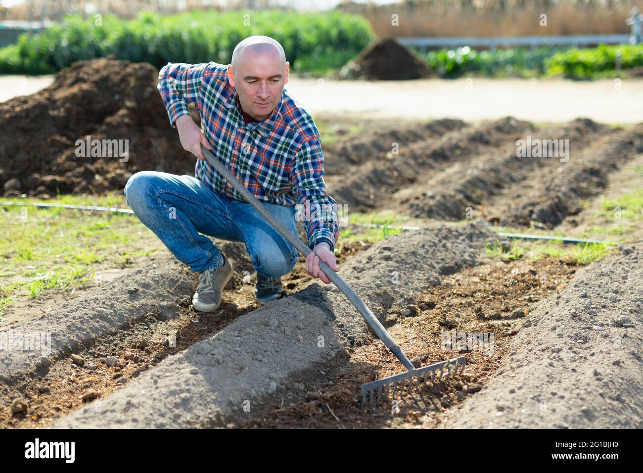 Portrait farmer holding rake hi-res stock photography and images - Alamy