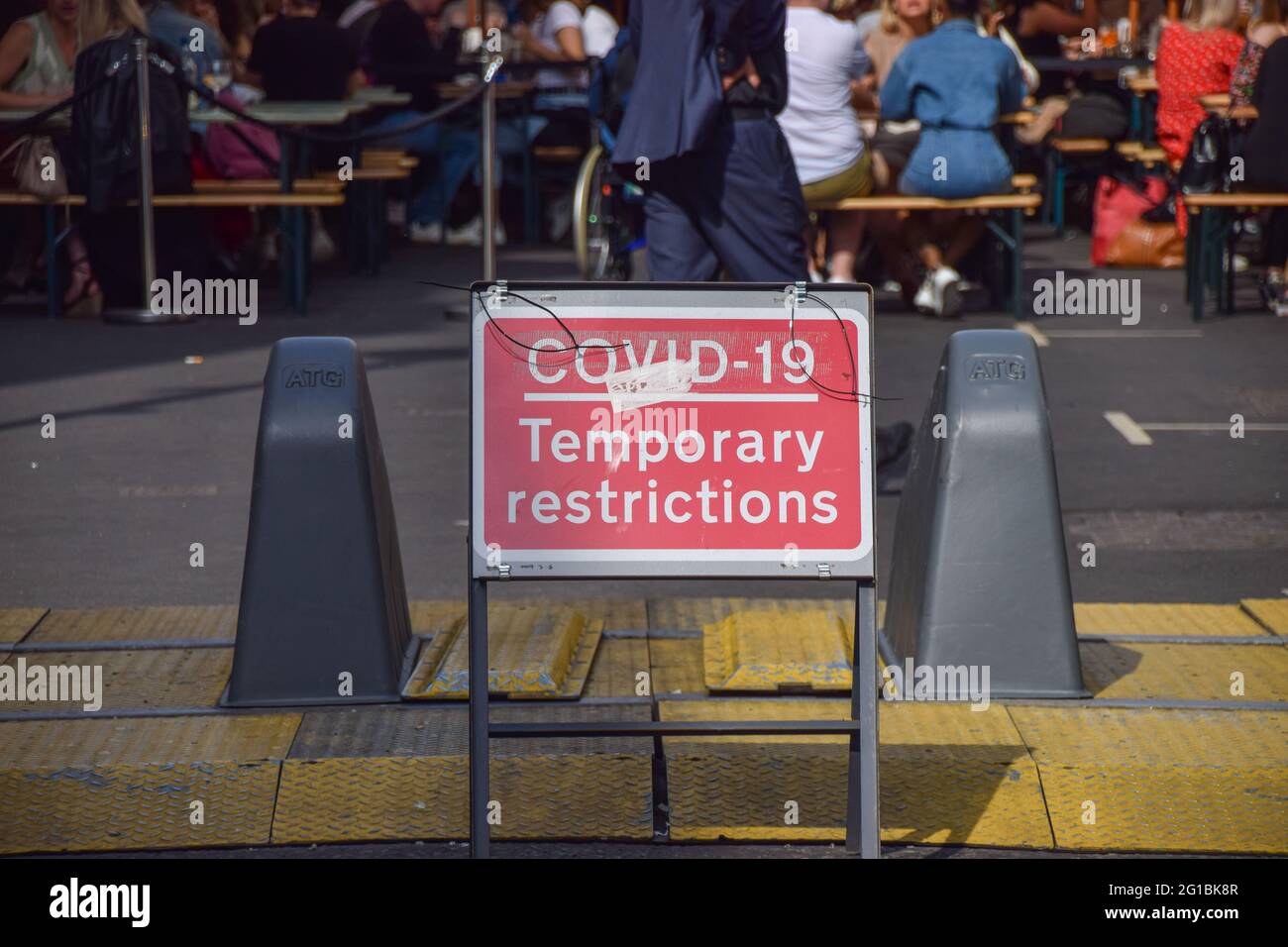 A COVID-19 Temporary Restrictions sign seen in Old Compton Street, Soho ...