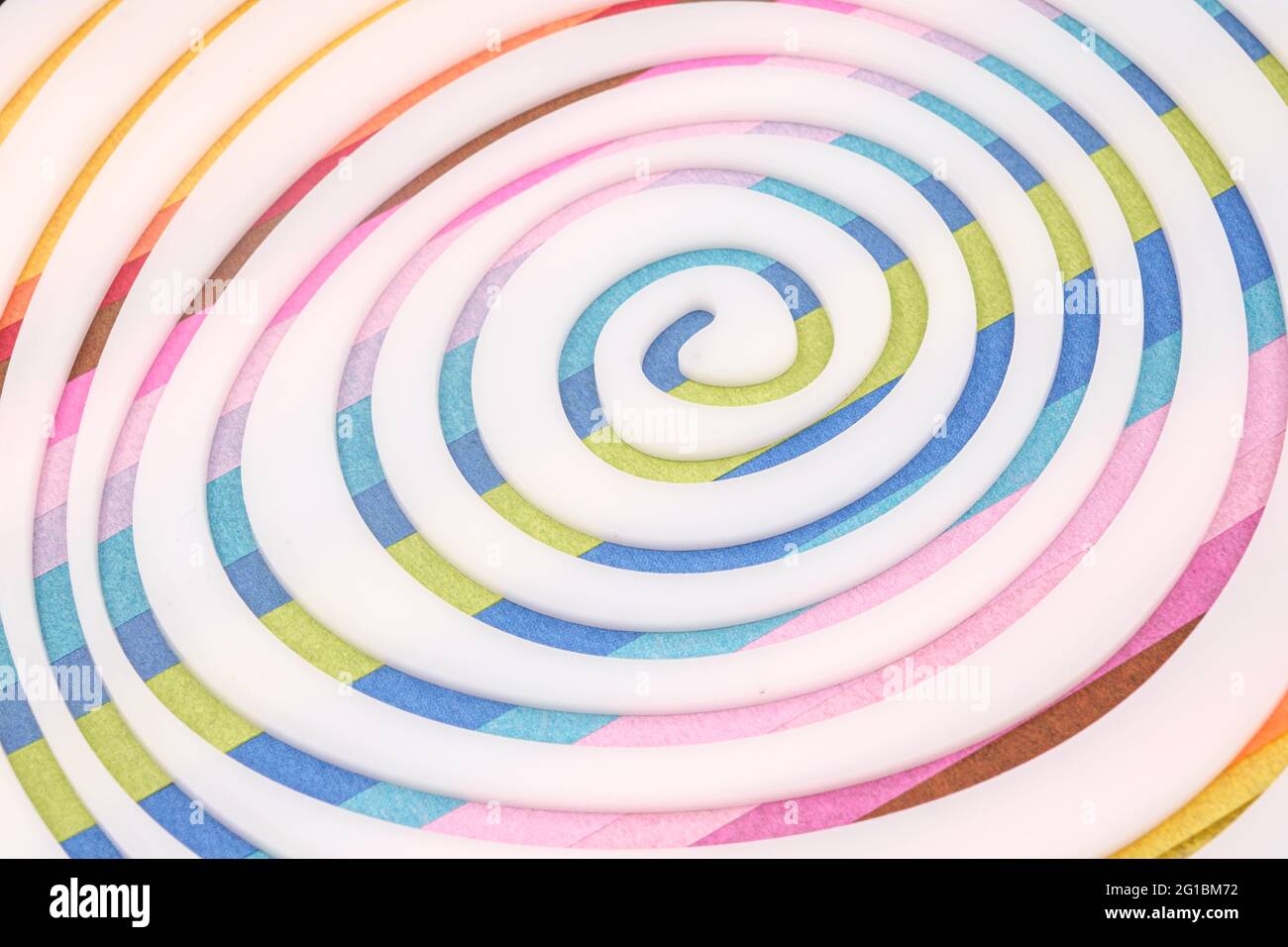 Simple white spiral on Multicolored paper background Stock Photo - Alamy