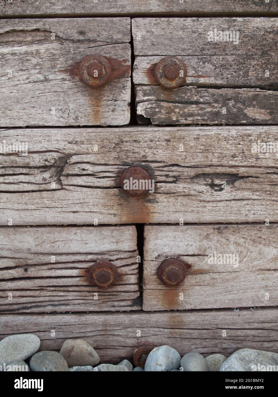 The rectangular wooden planks fastened with rusty large nails and ...