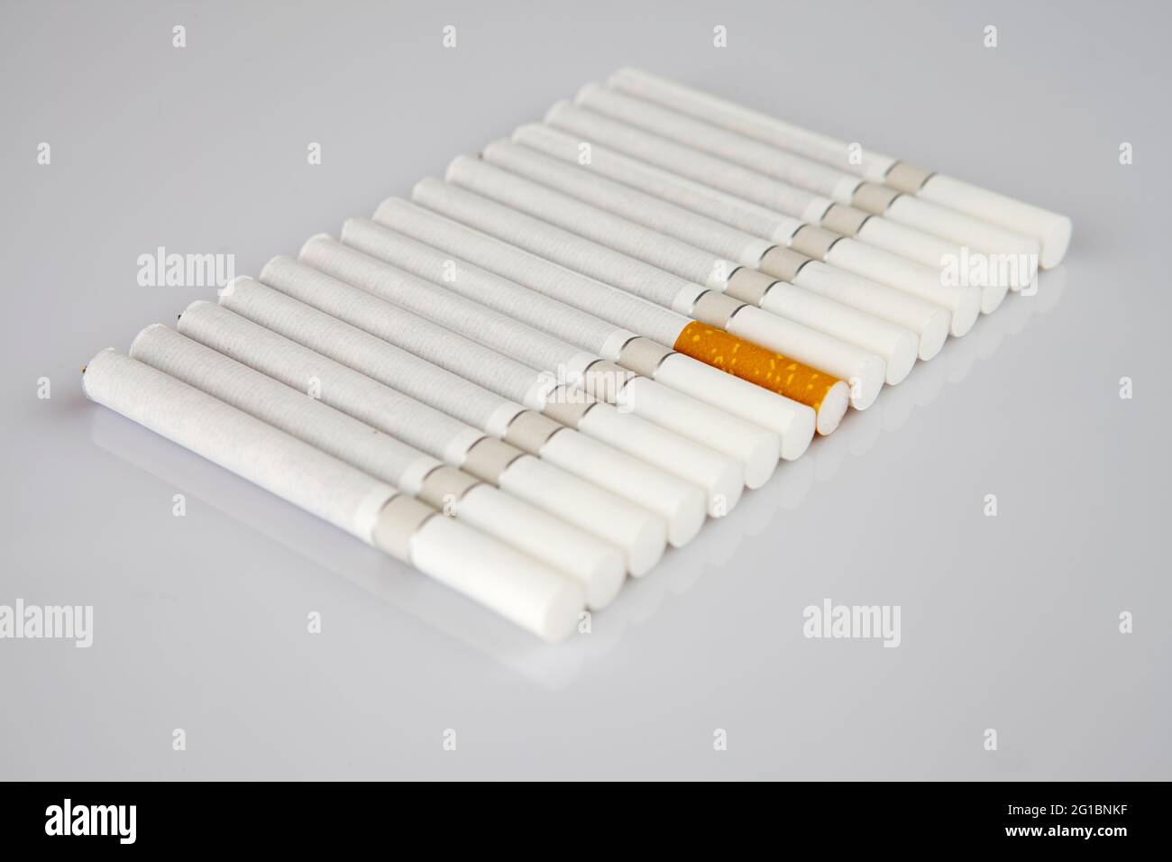 Pile of cigarettes over white background Stock Photo - Alamy