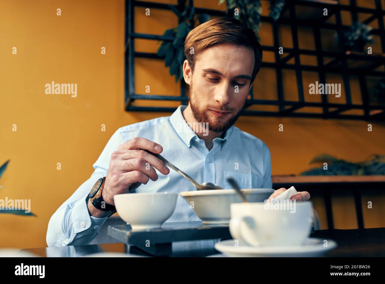 man eating lunch in a restaurant hot broth food break at work Stock ...