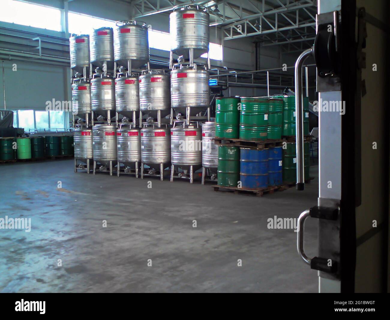 Production of raw materials, large barrels in the workshop at the plant ...