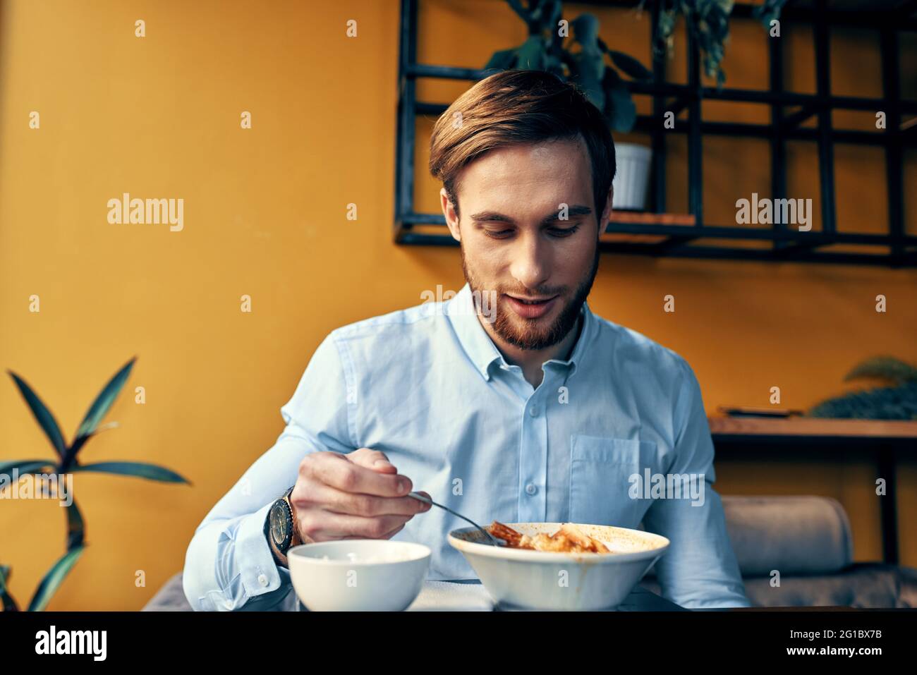 man eating lunch at cafe table break at work and interior Stock Photo ...