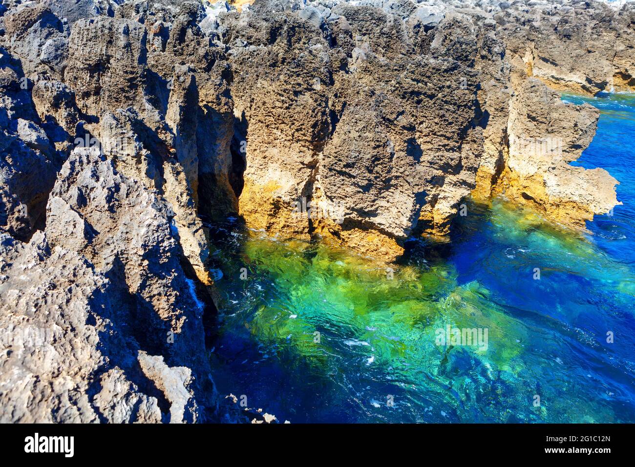 Coastal rock formation and ocean turquoise water . Tropical littoral ...